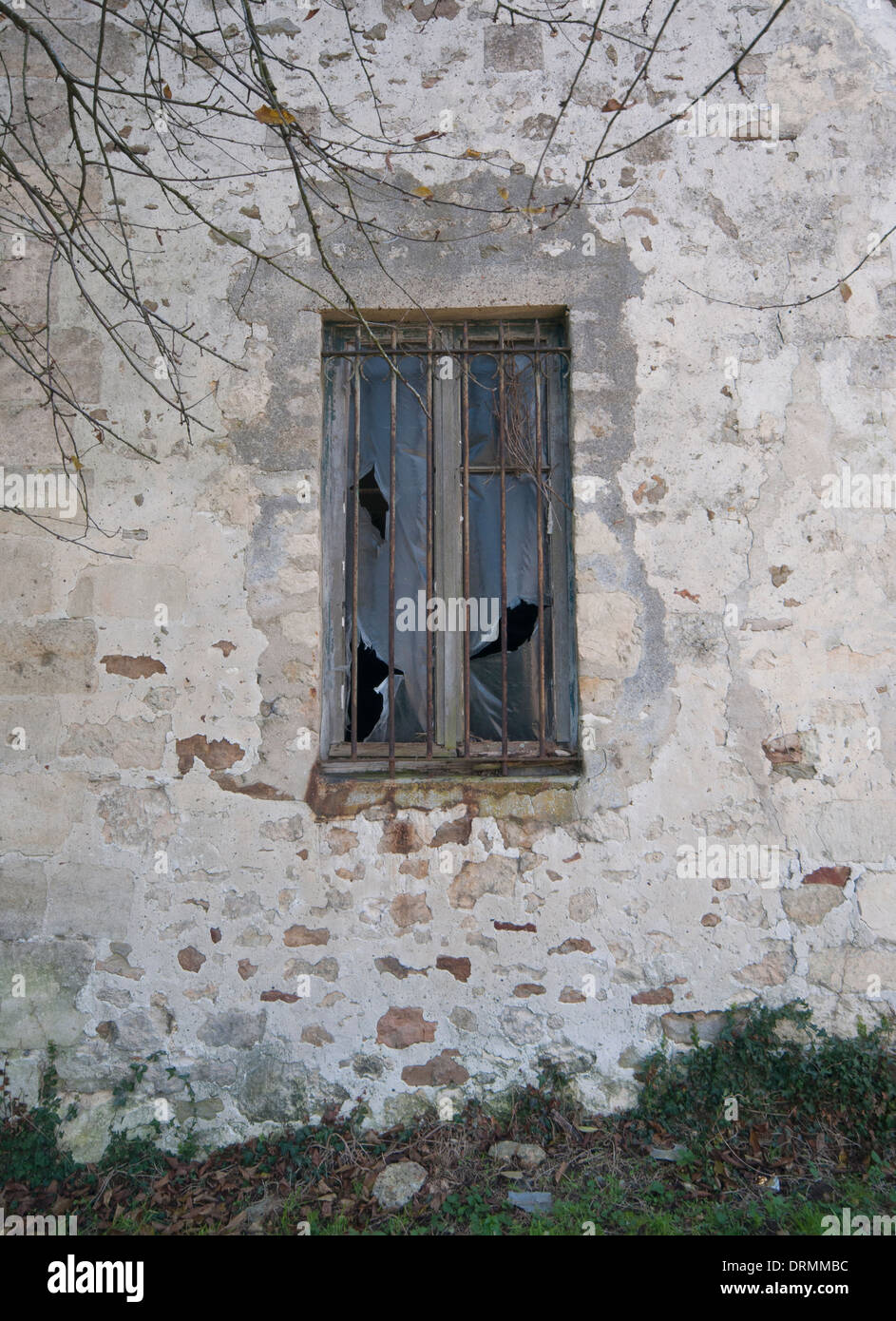 Old derelict broken window with metal bars Stock Photo - Alamy