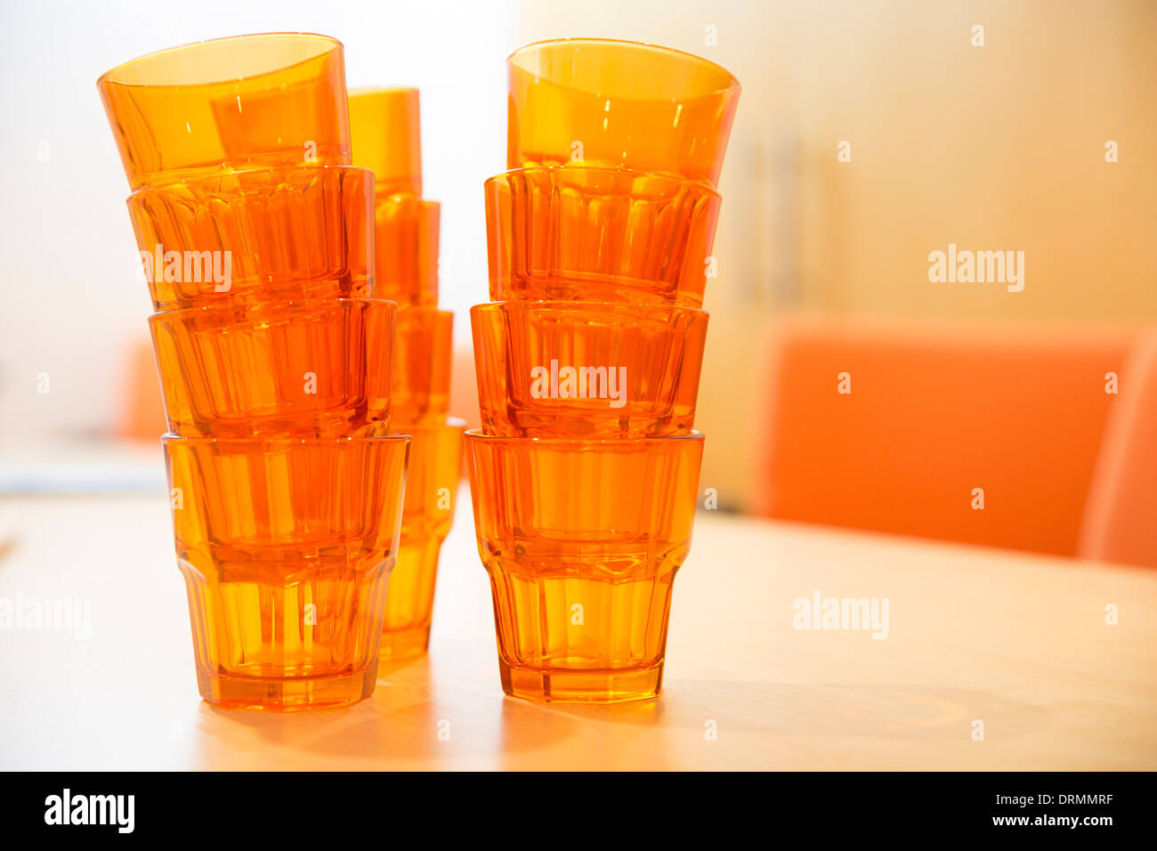 stacks of orange water glasses in meeting room Stock Photo - Alamy