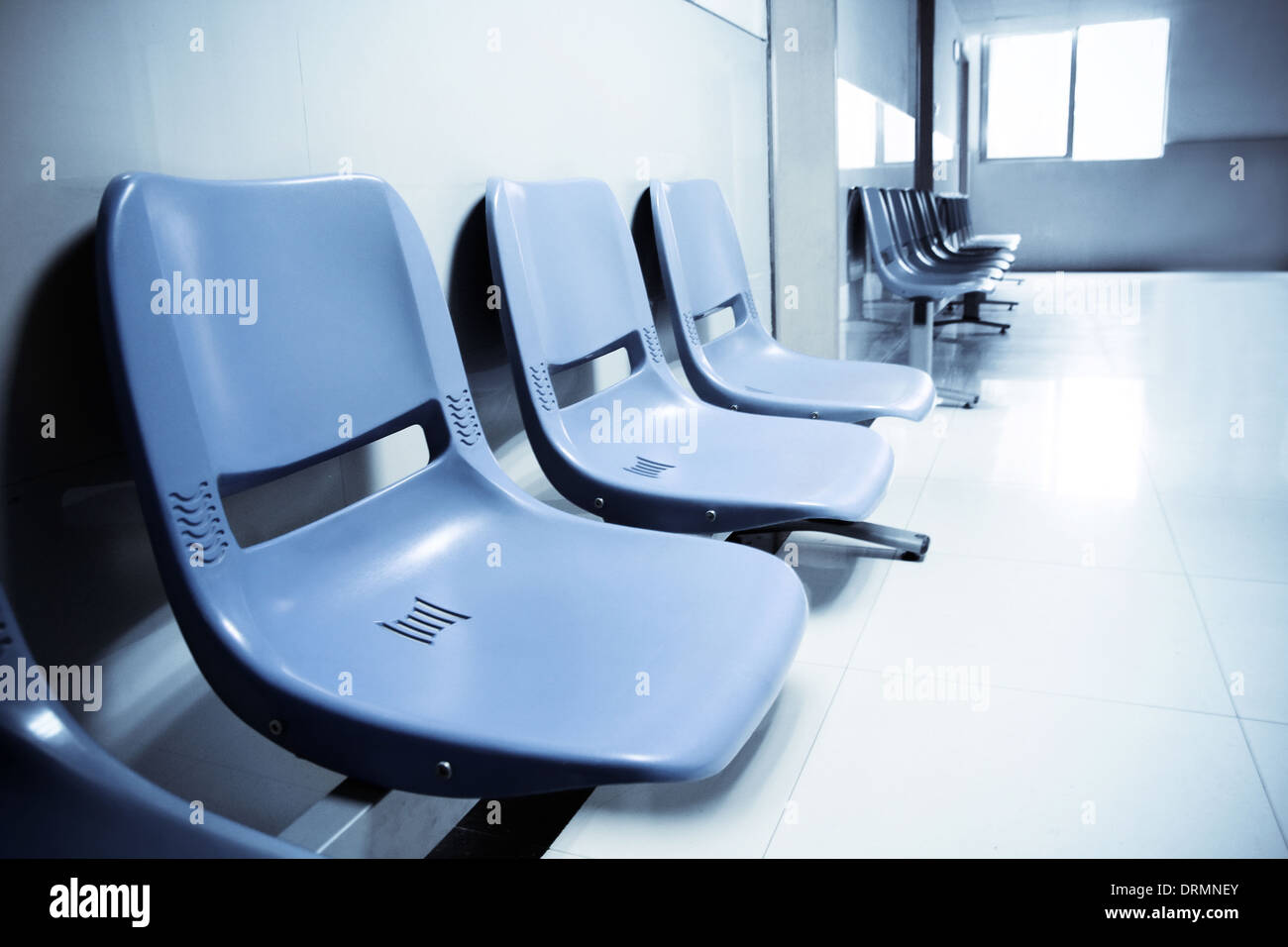 Waiting room blue chairs hi-res stock photography and images - Alamy