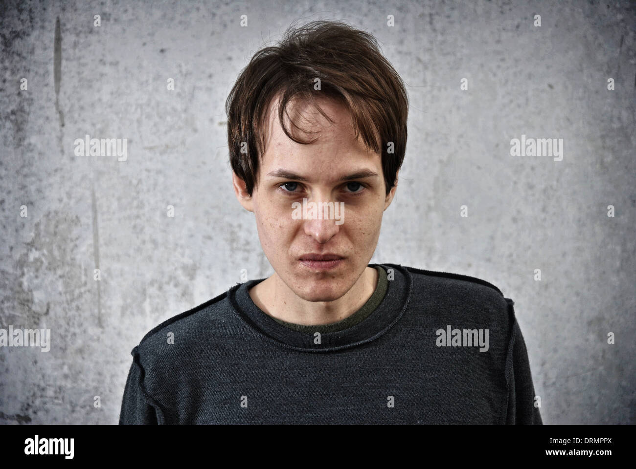 Crazy young man with the face of evil Stock Photo - Alamy