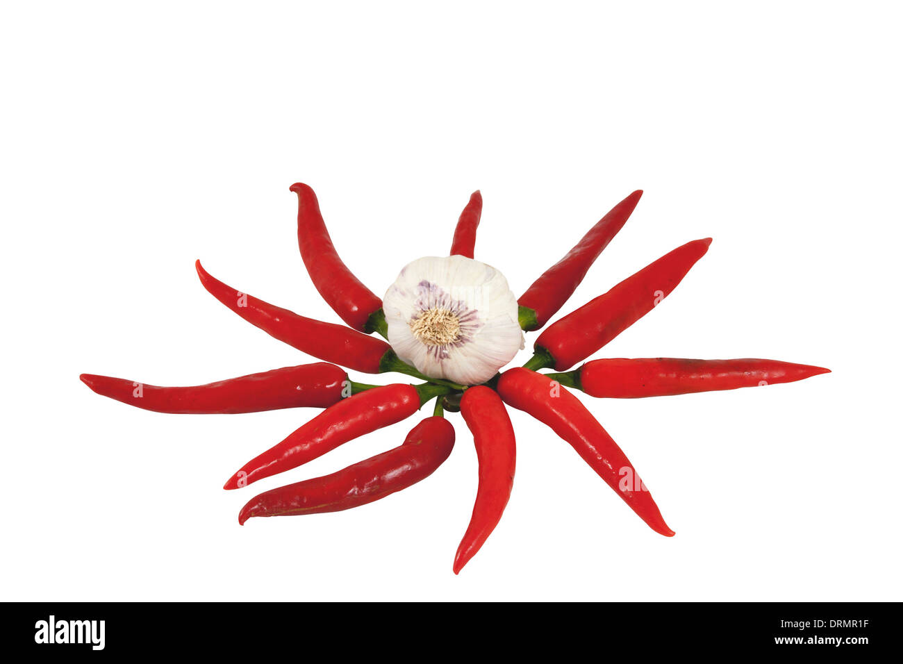 garlic bulb in center of circular red chili display Stock Photo - Alamy