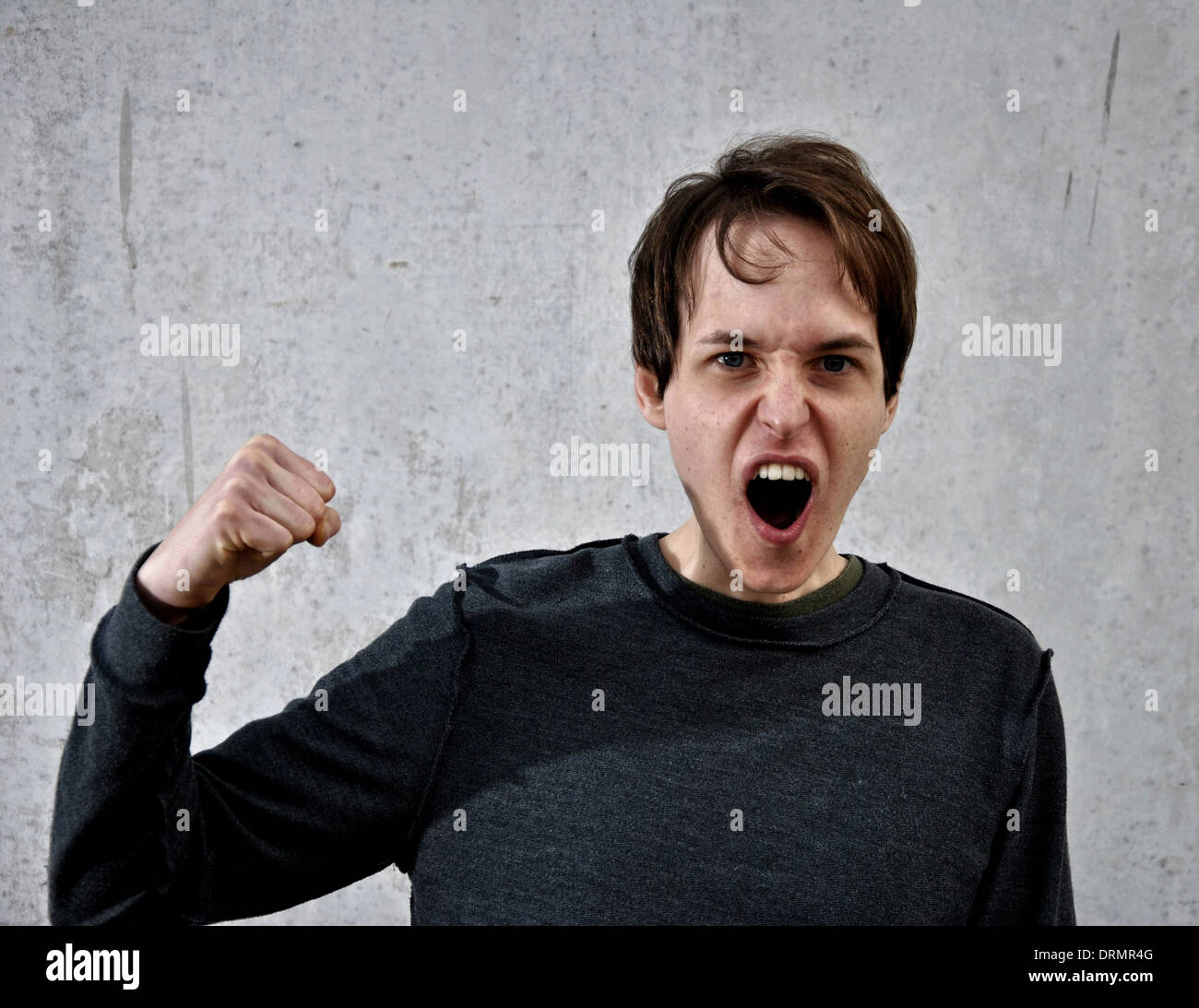 very angry young man with clenched fists and feel like hitting Stock ...