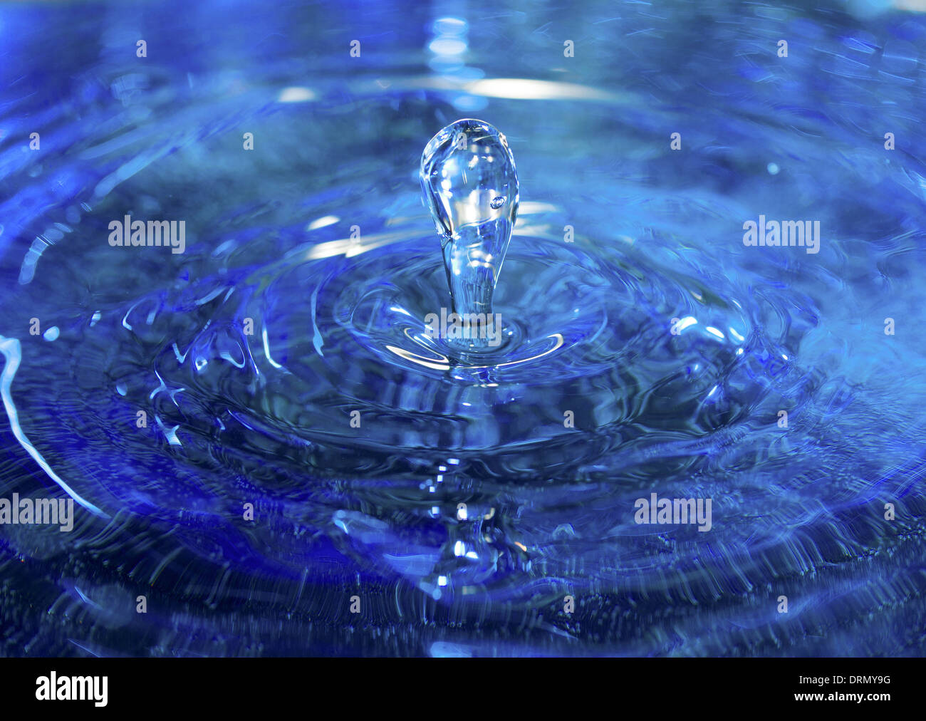 Abstract drop falling into water Stock Photo - Alamy