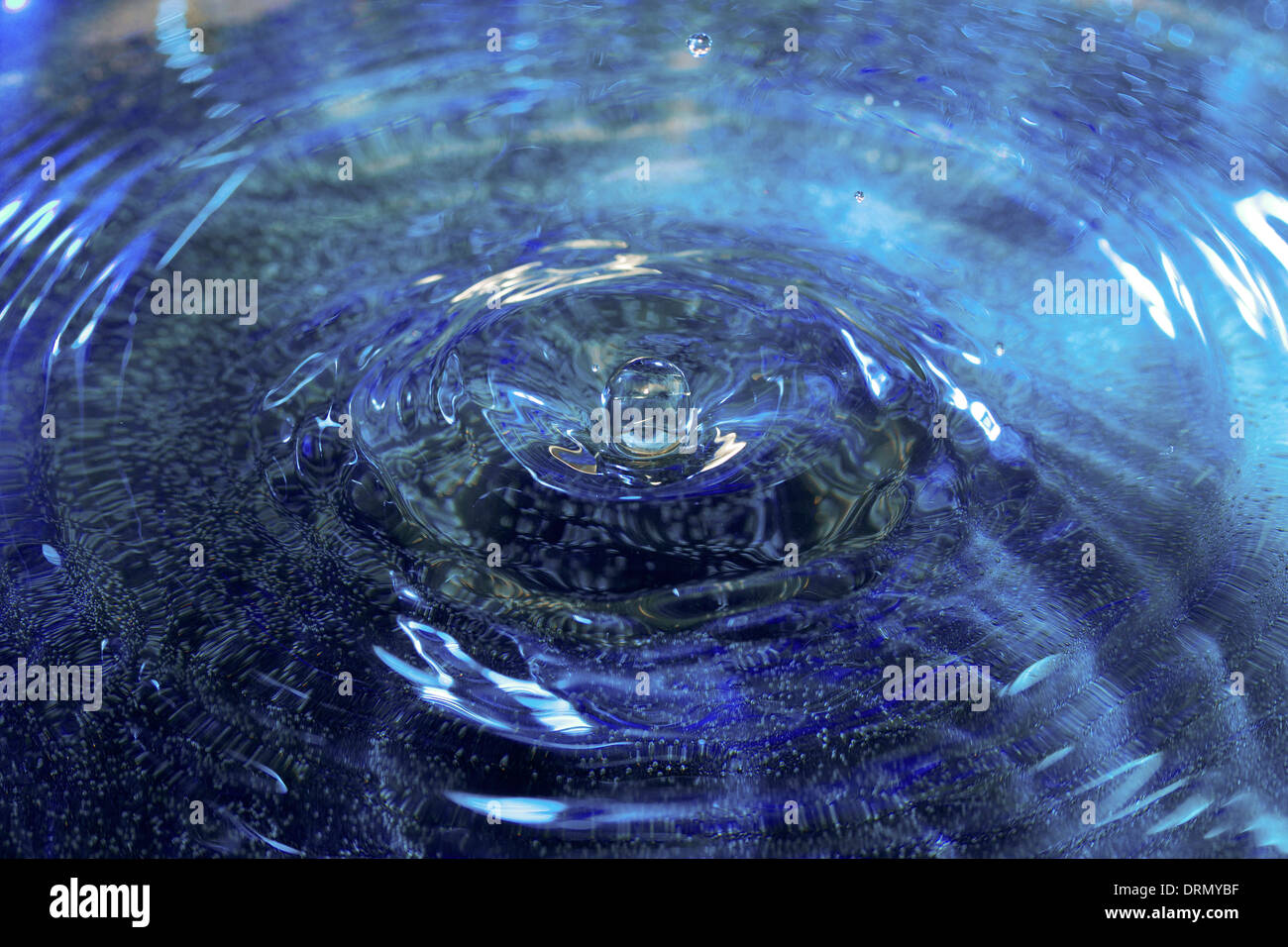 Abstract drop falling into water Stock Photo - Alamy
