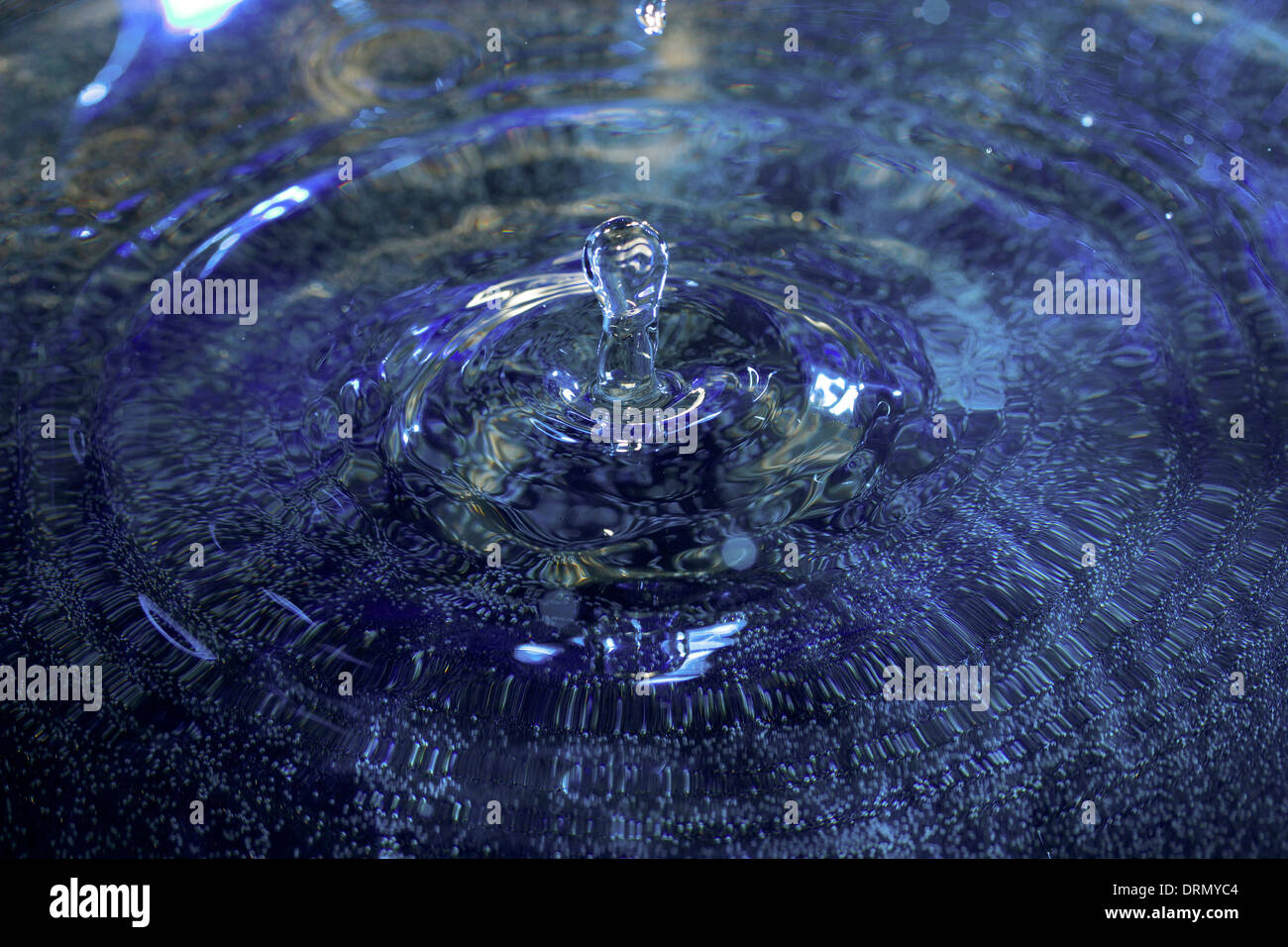 Abstract drop falling into water Stock Photo - Alamy