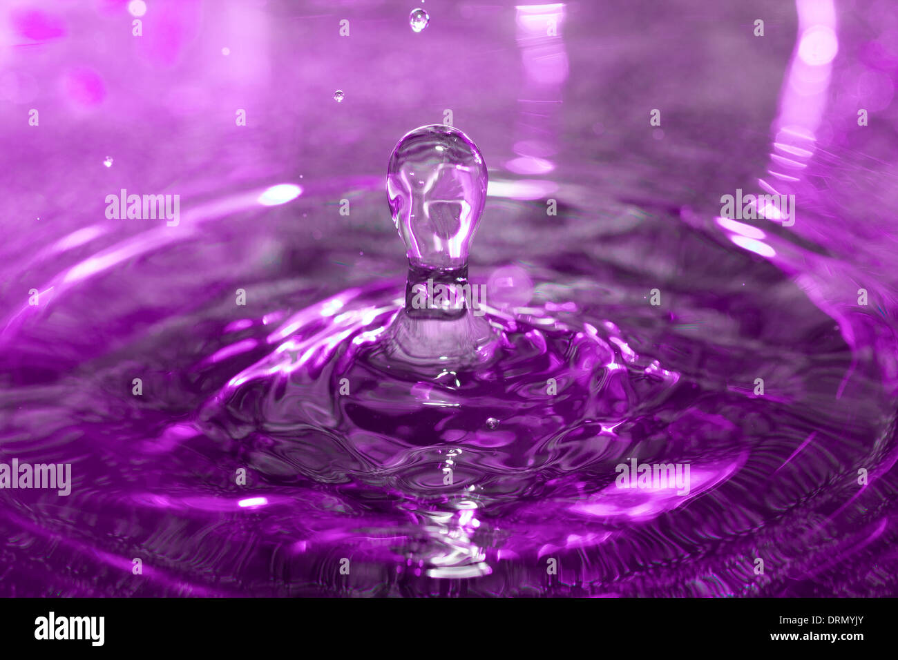 Abstract drop falling into water Stock Photo - Alamy