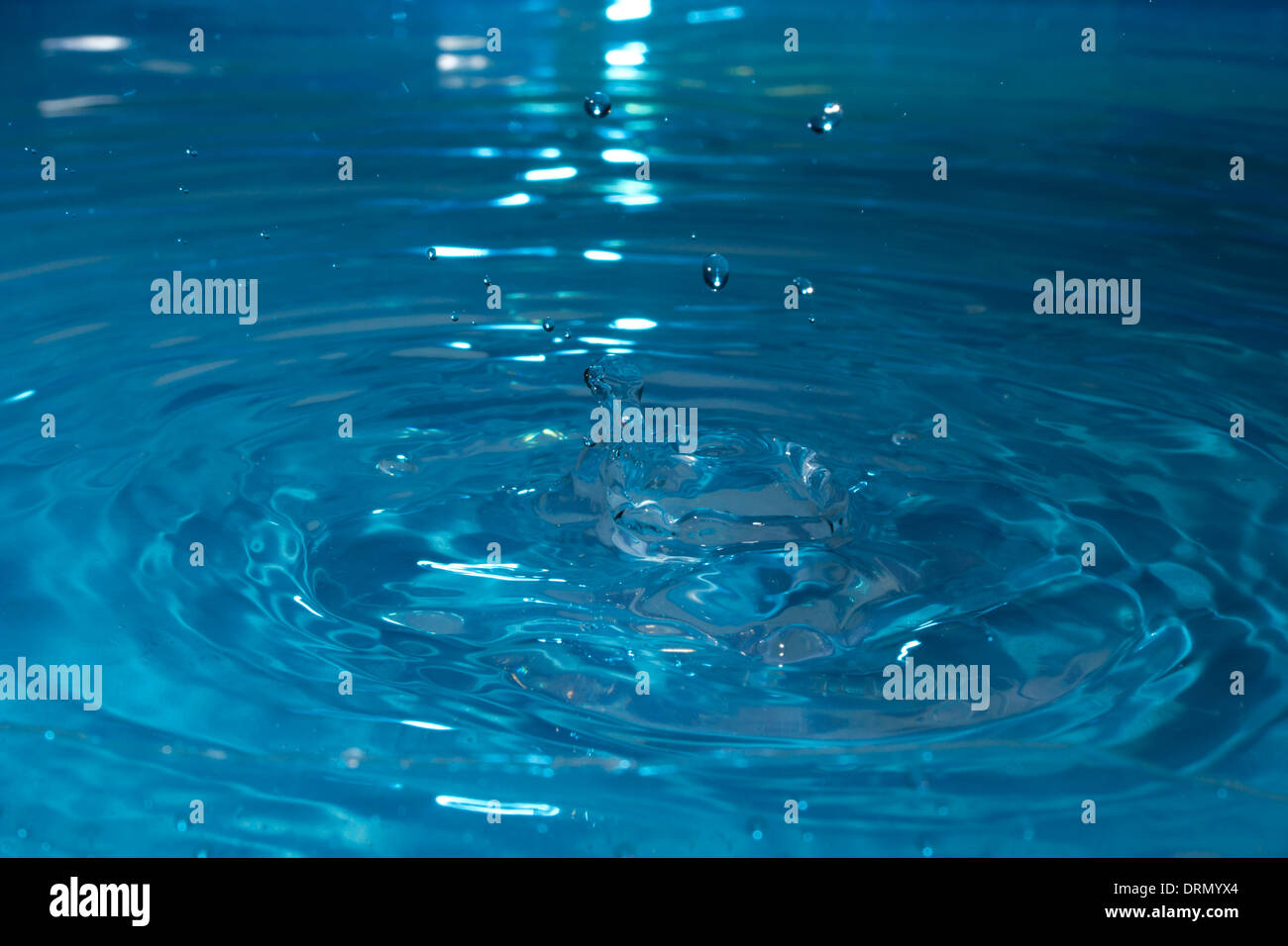 Abstract drop falling into water Stock Photo - Alamy