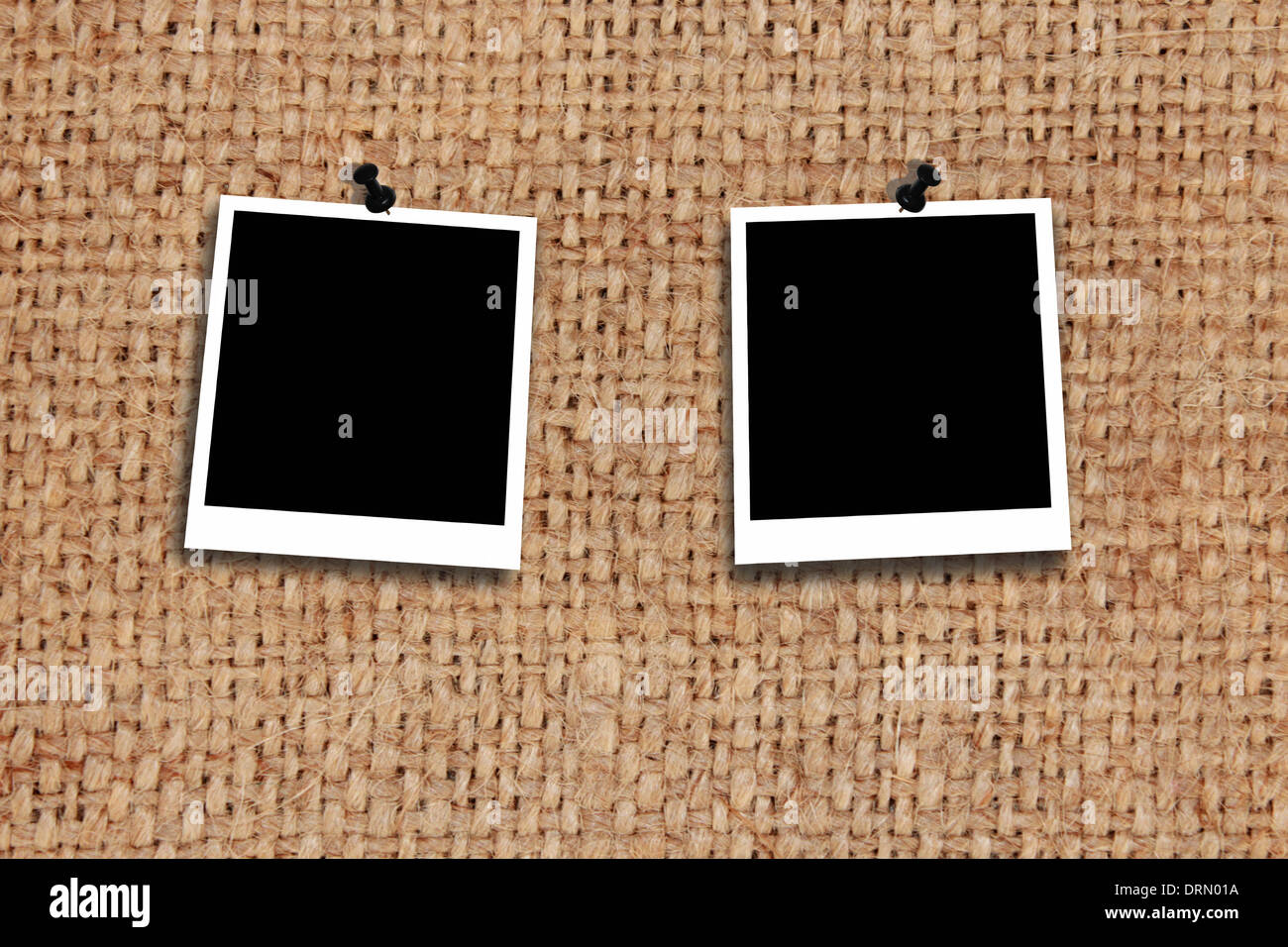 two empty photos stuck by pin to the texture of grey sacking Stock ...