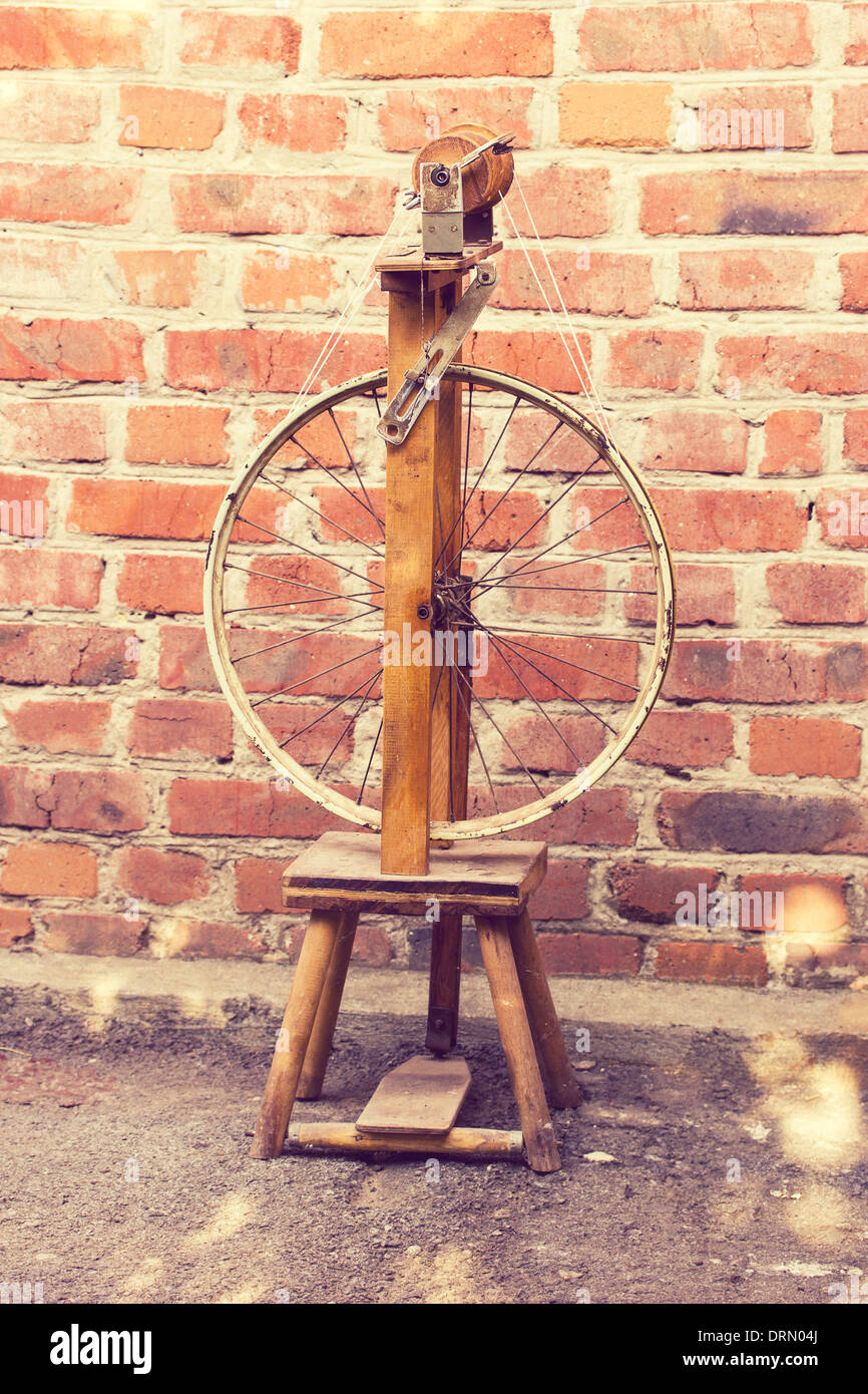 Spinning in vintage style on a brick wall Stock Photo - Alamy