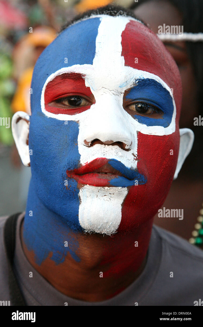 Carnival participant with Dominican national flag on his face performs ...