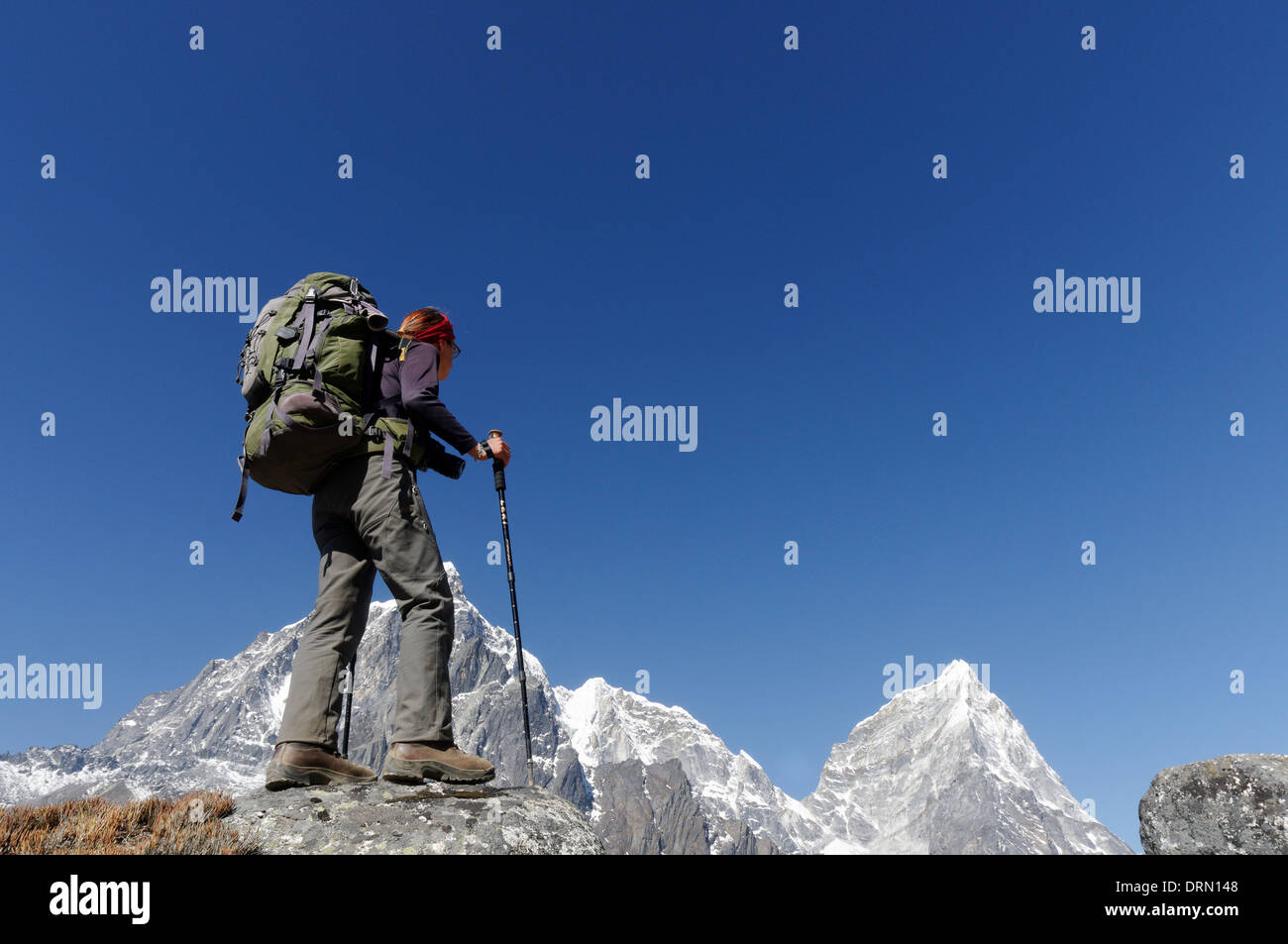 A lady trekker passes Cholatse peak on the Everest Base Camp trek Stock ...
