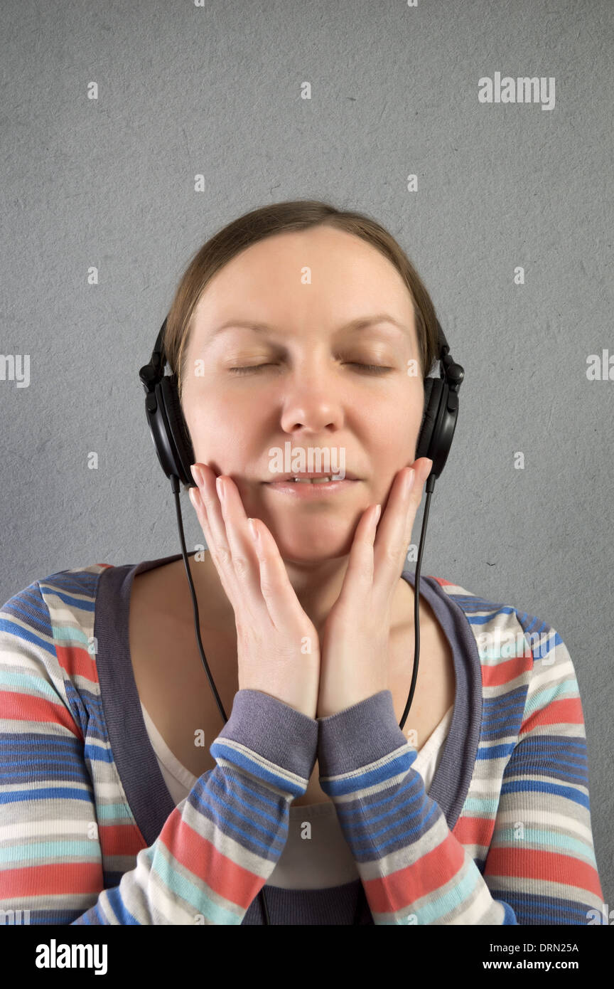 Adult listening to headphones hi-res stock photography and images - Alamy