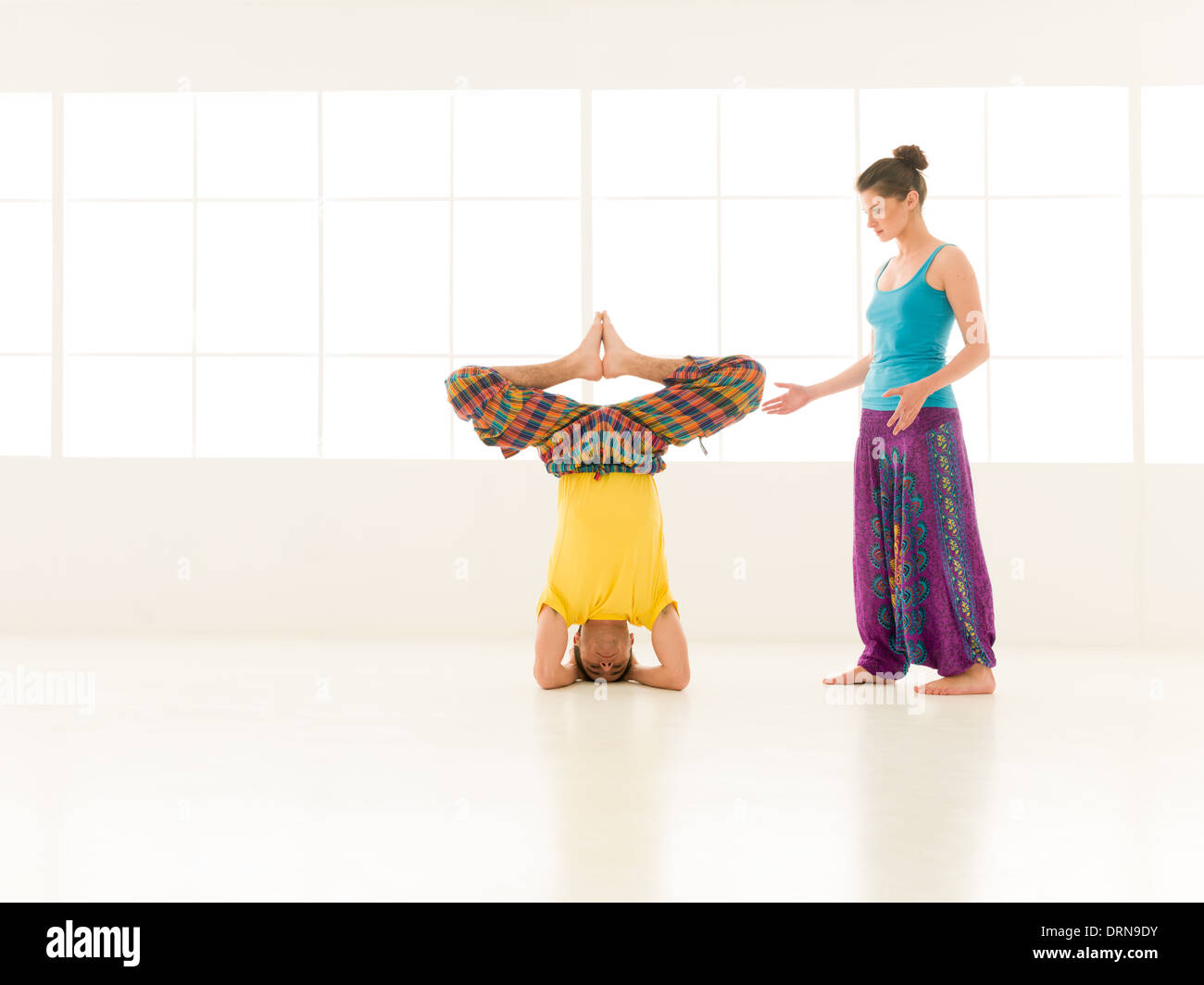 beautiful woman instructor with a handsome man dressed in vibrant ...