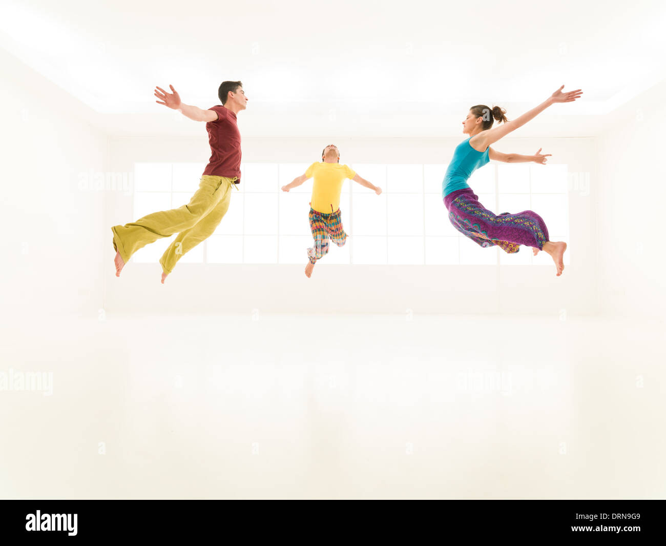 colorful young people are freestyling in stydio white background glass ...