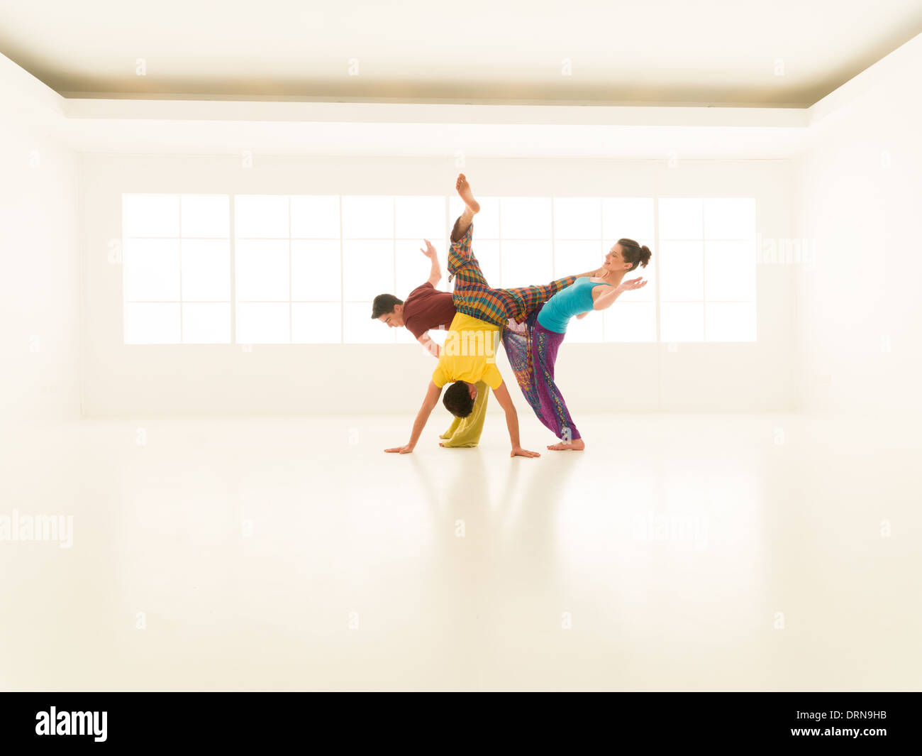 colorful young people are freestyling in stydio white background glass ...