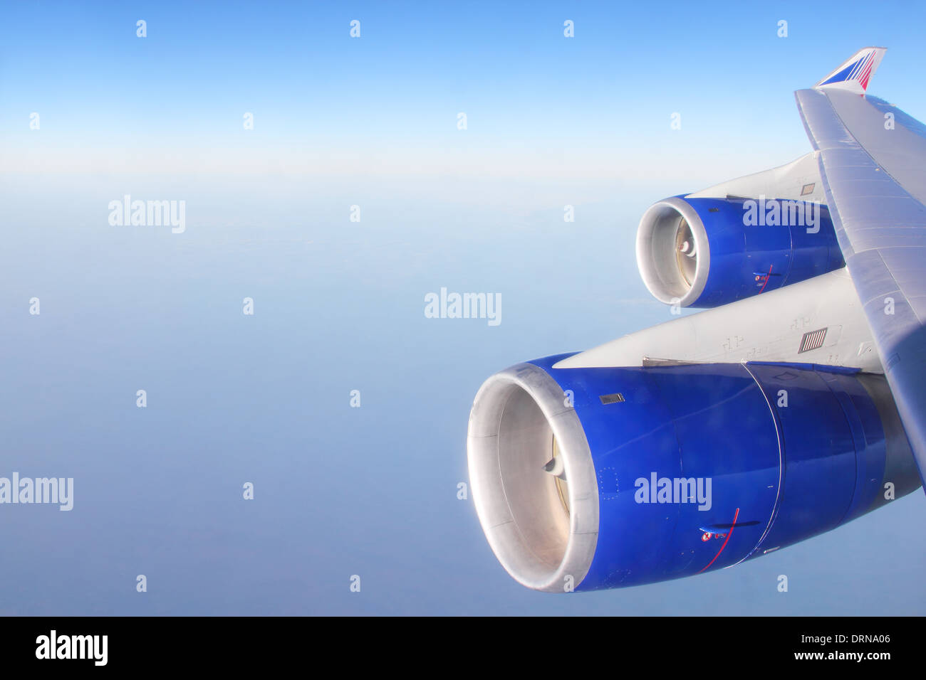 Turbine of passenger airplane flying in blue sky over clouds Stock ...