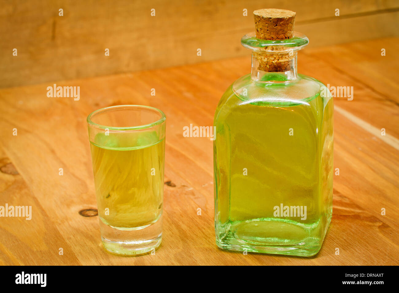 Peppermint liqueur bottle and shot on wooden background Stock Photo - Alamy