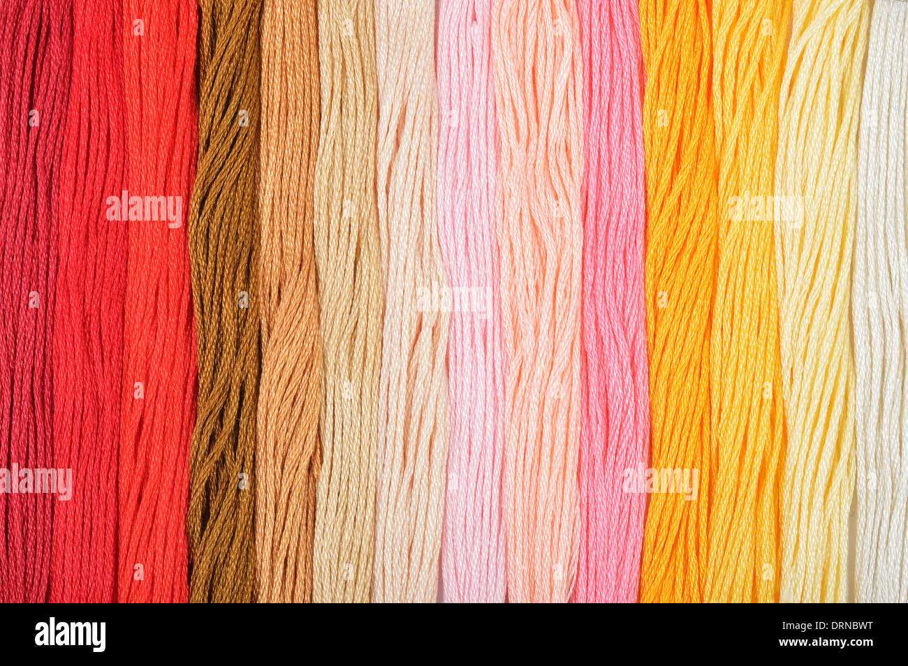 Colorful embroidery threads in a row. Warm colors background Stock ...