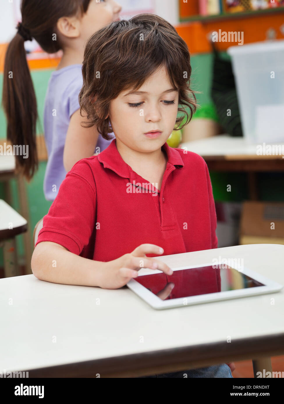 Little Boy Using Digital Tablet In Kindergarten Stock Photo - Alamy