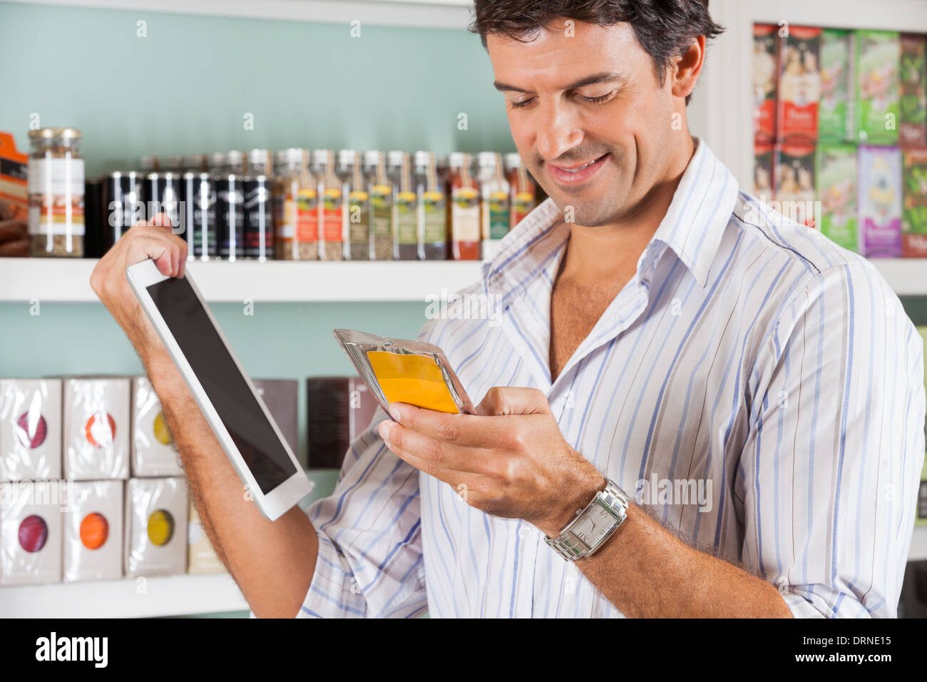 Man With Digital Tablet Checking Product In Store Stock Photo - Alamy