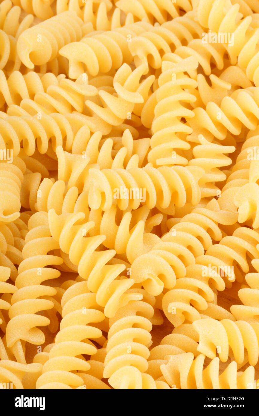 Raw durum wheat fusilli pasta background Stock Photo - Alamy