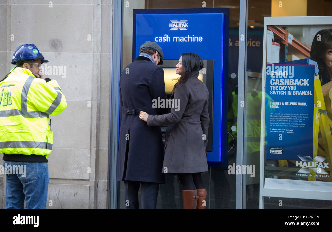 Couple cuddling cashpoint halifax bank hi-res stock photography and ...