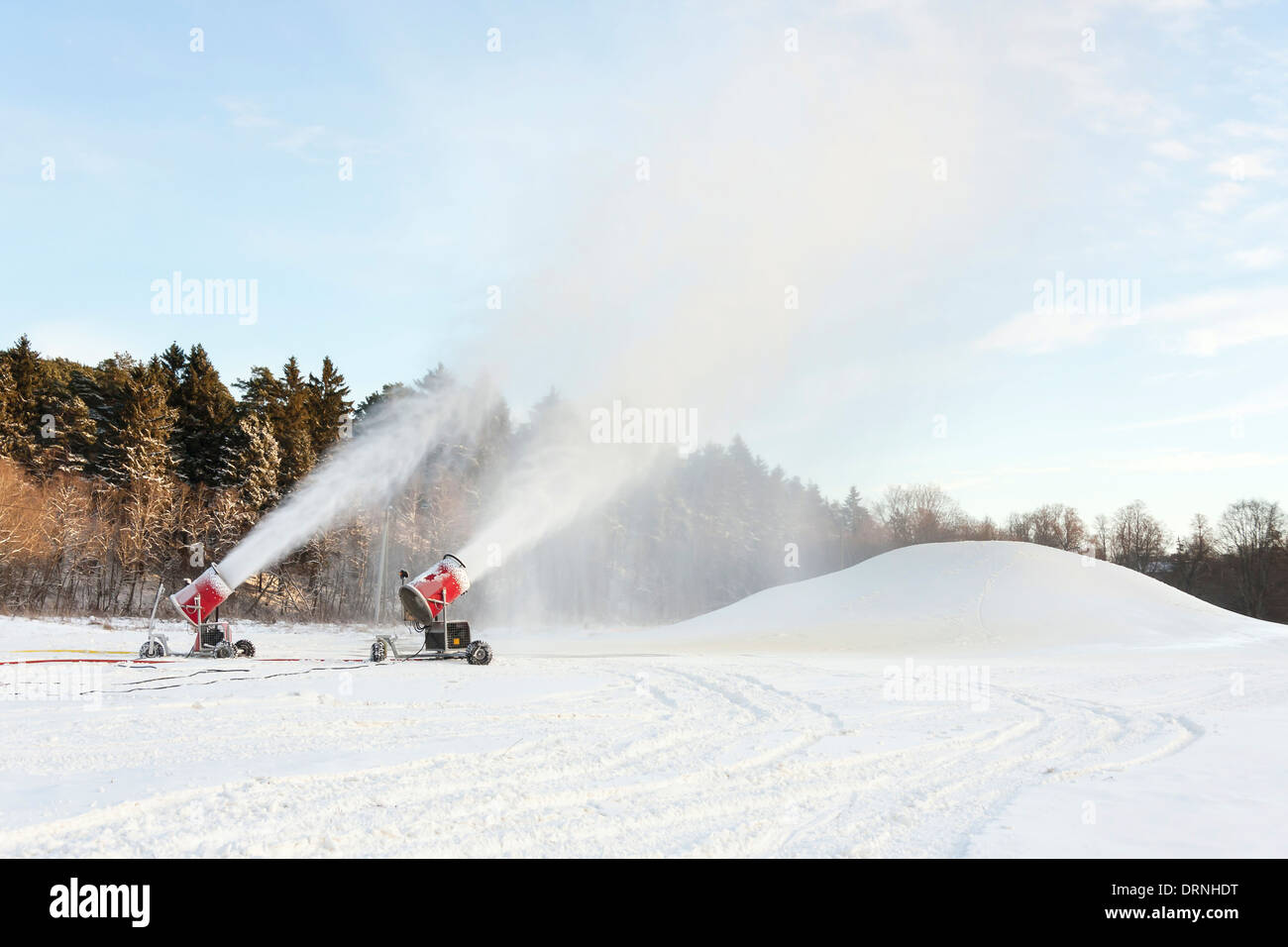 Snow blowing machines or snow cannons making snow Stock Photo - Alamy