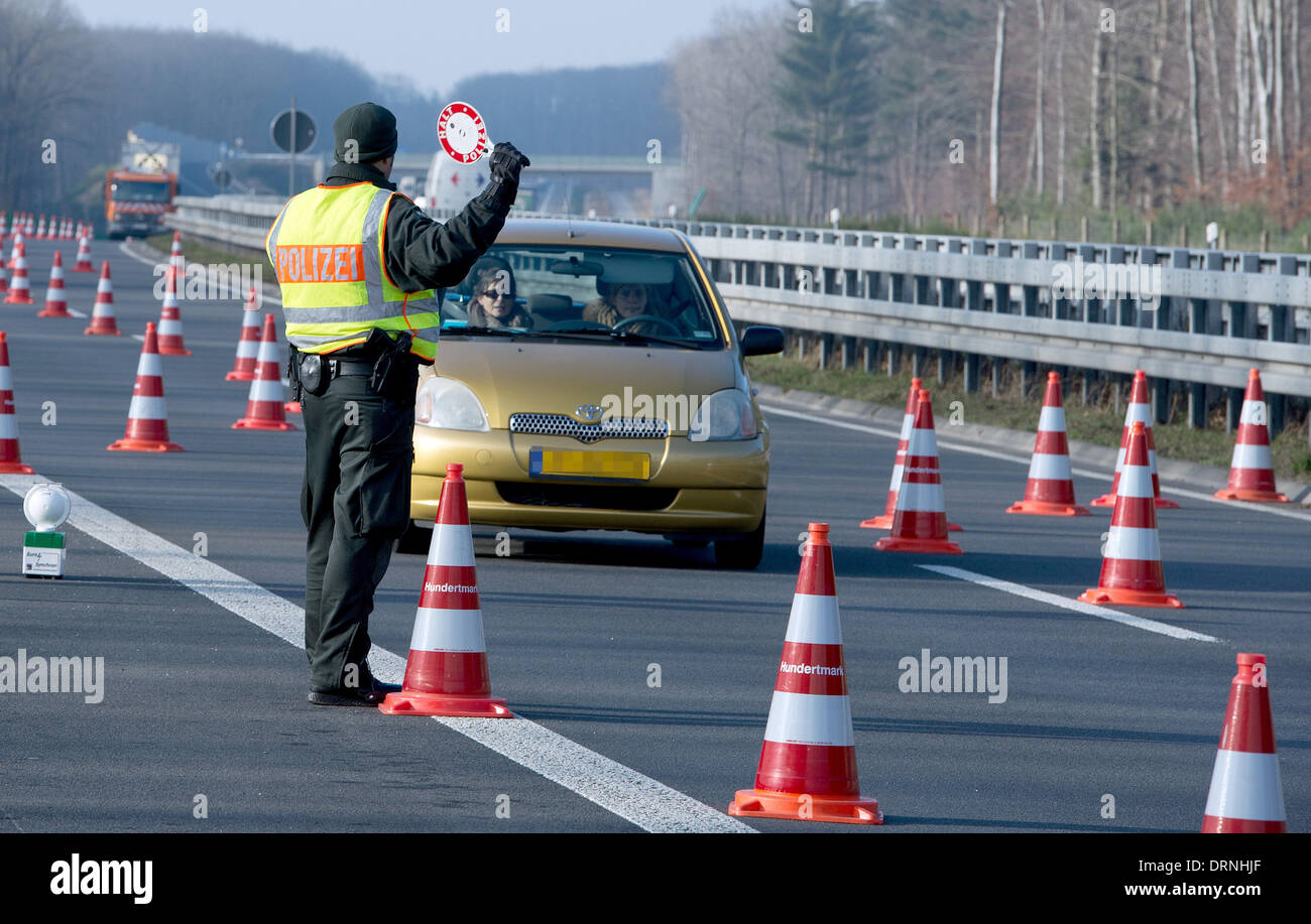 A police officer stops a car on the A52 Autobahn on the Dutch border ...
