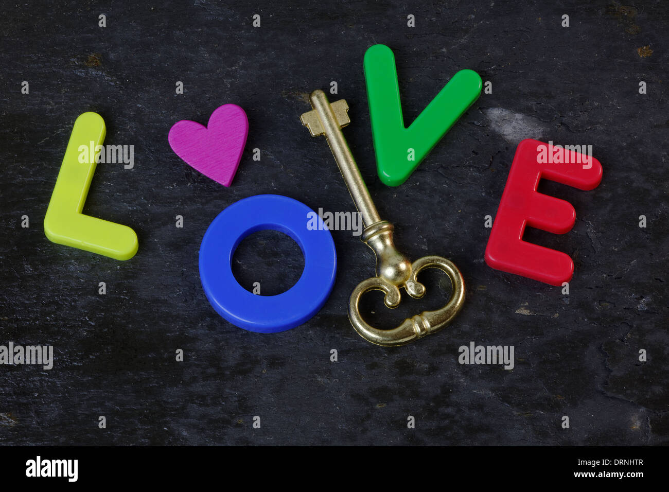 Antique key on a slate background with the word love in letters Stock ...