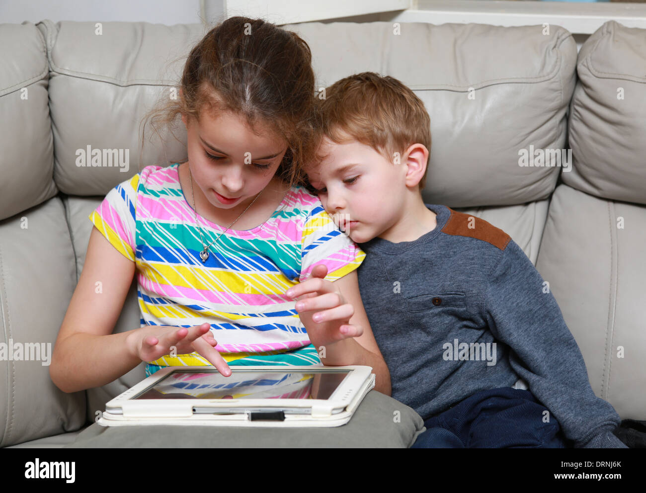 Children playing on ipad Stock Photo - Alamy