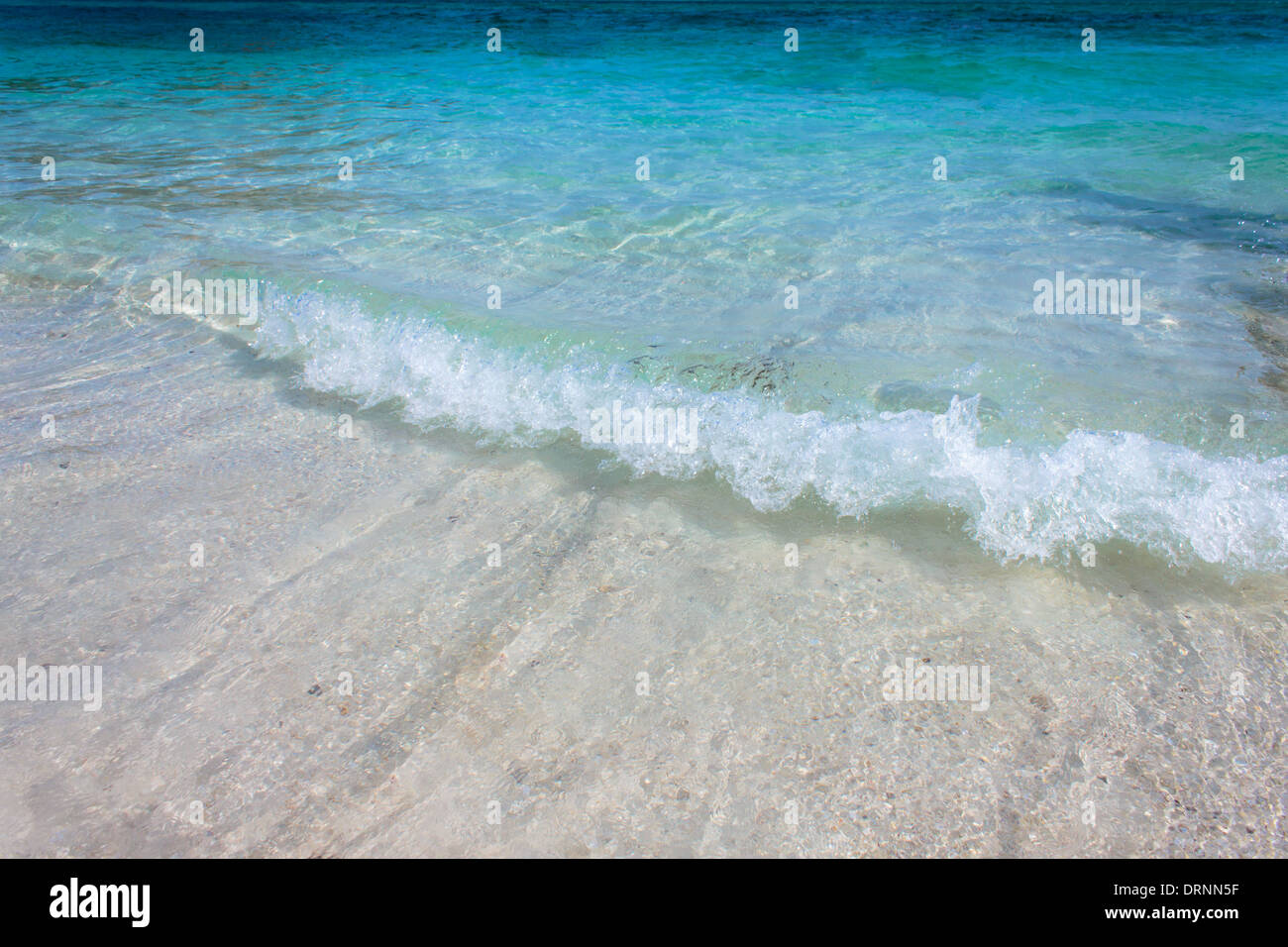 Wave of the sea on the sand beach Stock Photo - Alamy