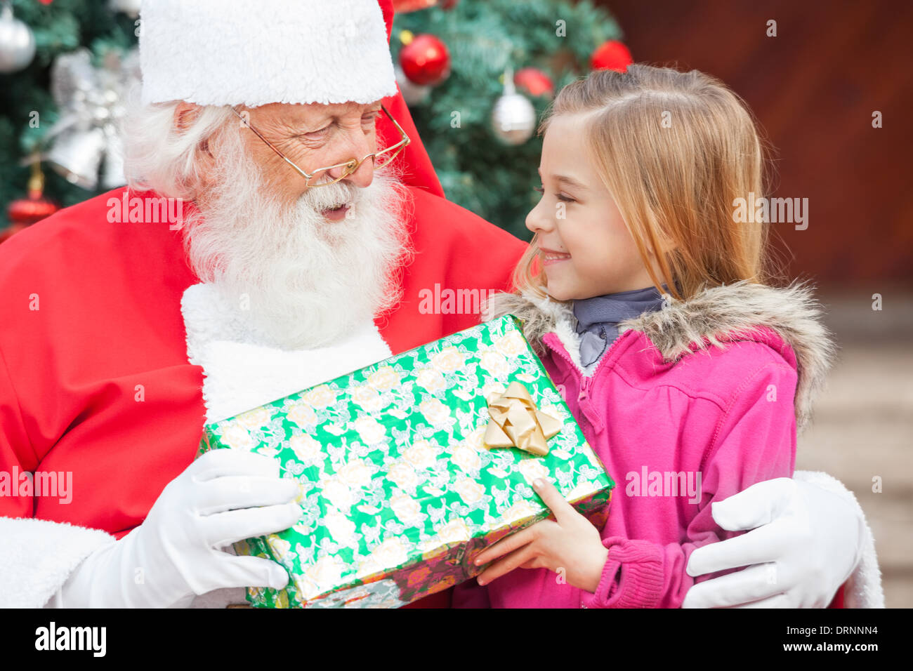 Santa Claus Giving Christmas Present To Girl Stock Photo - Alamy