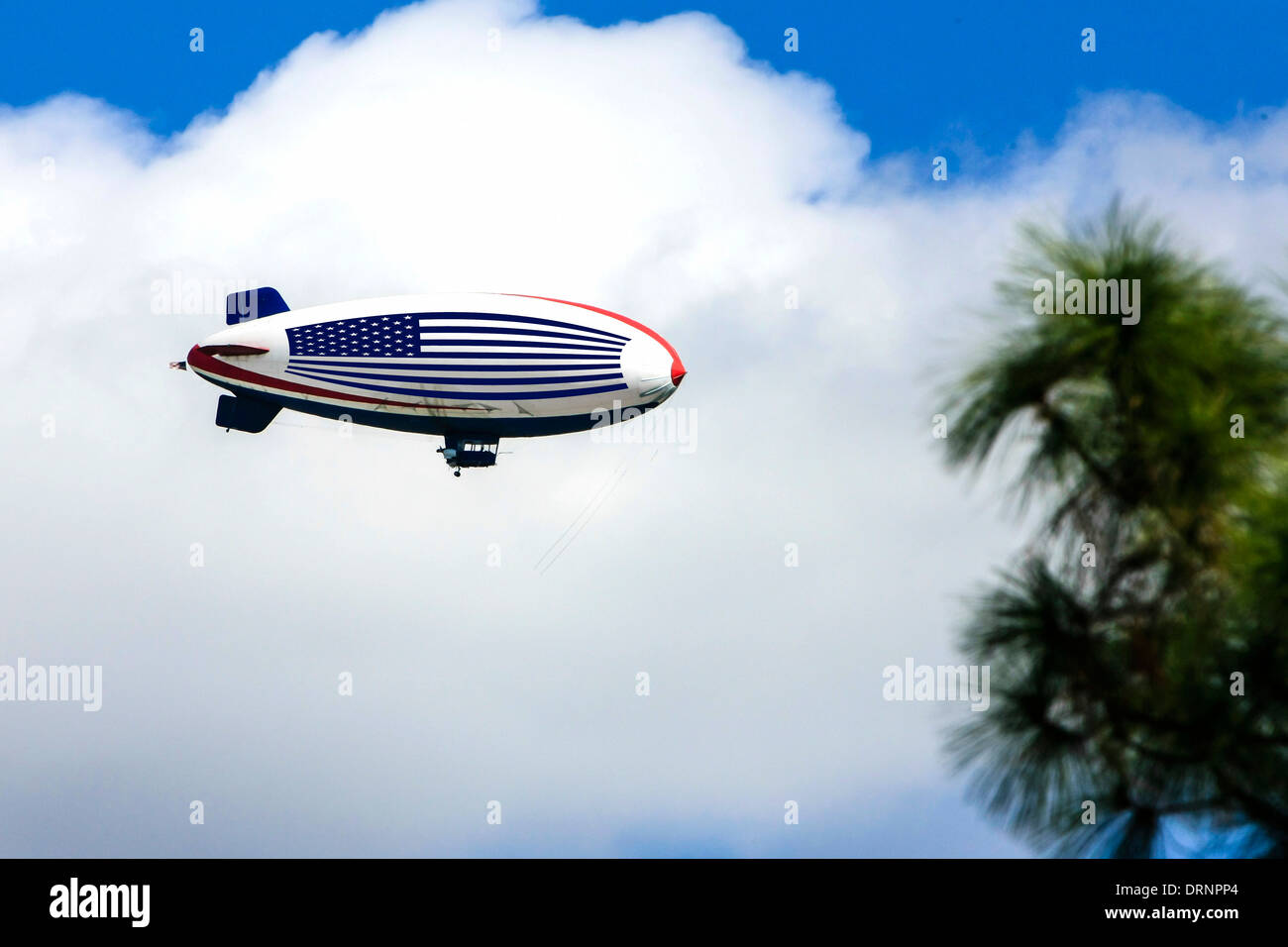 An American Flag toting airship flying around the blue skies of Florida ...