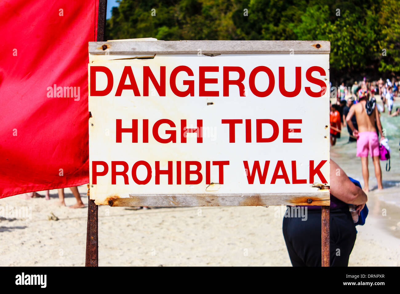 Beach sign that says, Dangerous High Tide Prohibit Walk Stock Photo - Alamy