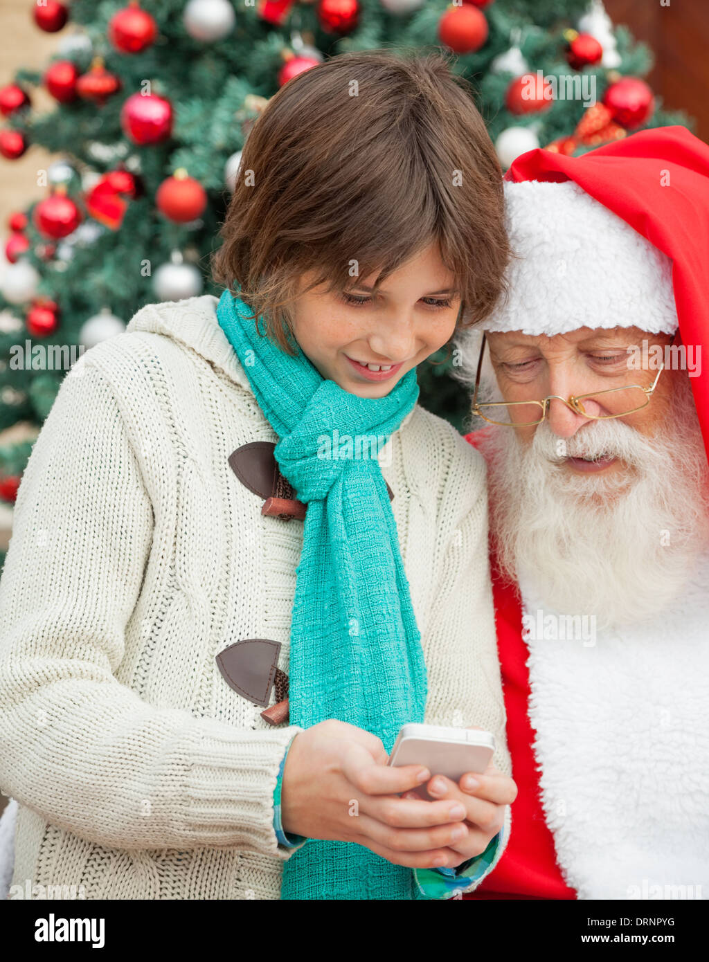 Santa claus smartphone christmas tree hi-res stock photography and ...