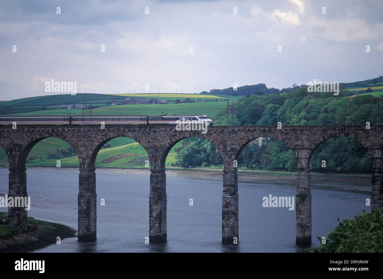 UK, Intercity train travelling across bridge, East Coast Stock Photo ...