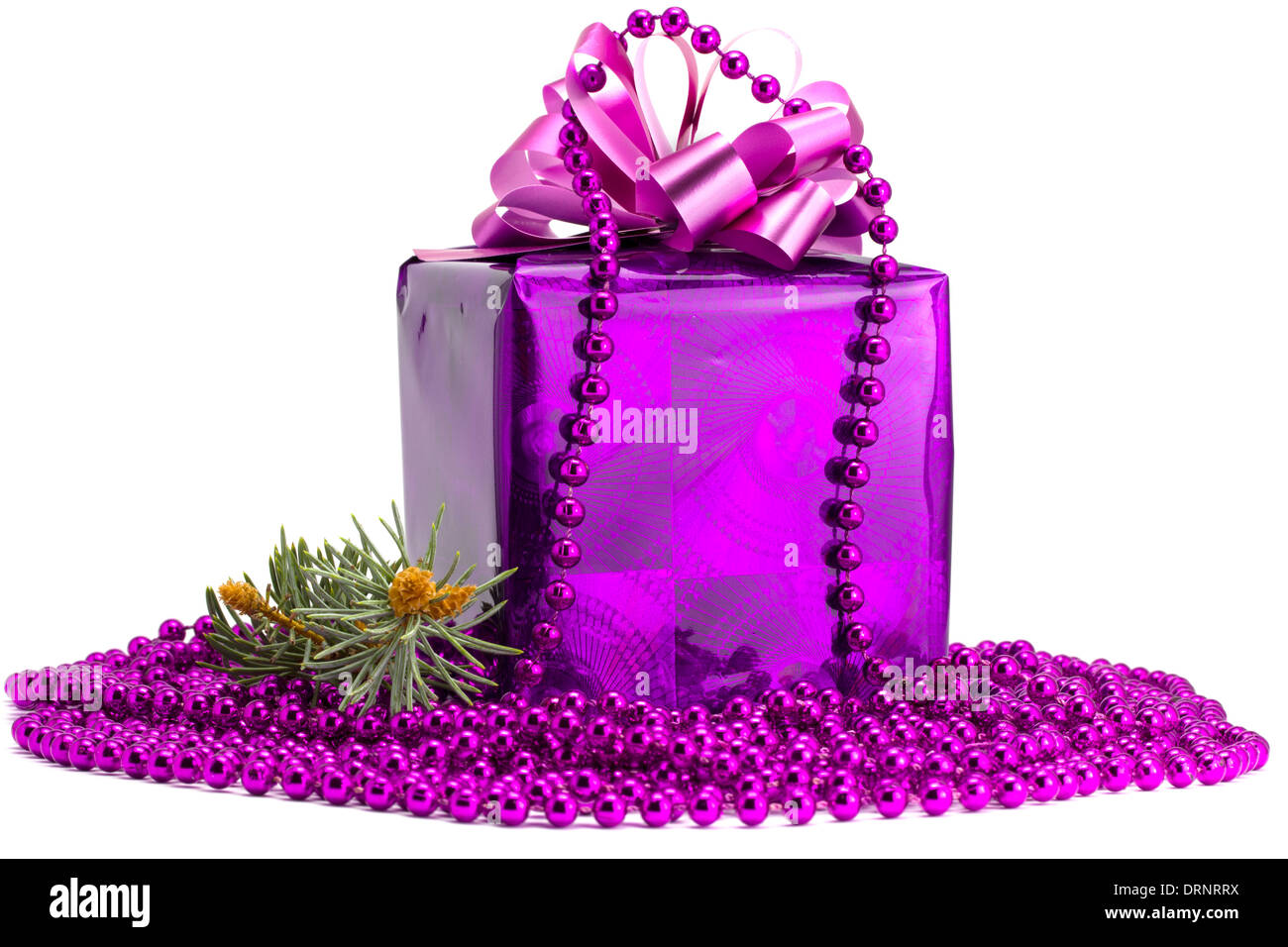 Violet gift with an ornament and a fur-tree on the white isolated ...