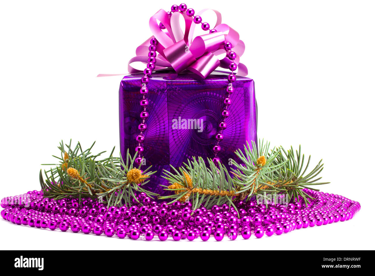 Violet gift with an ornament and a fur-tree on the white isolated ...