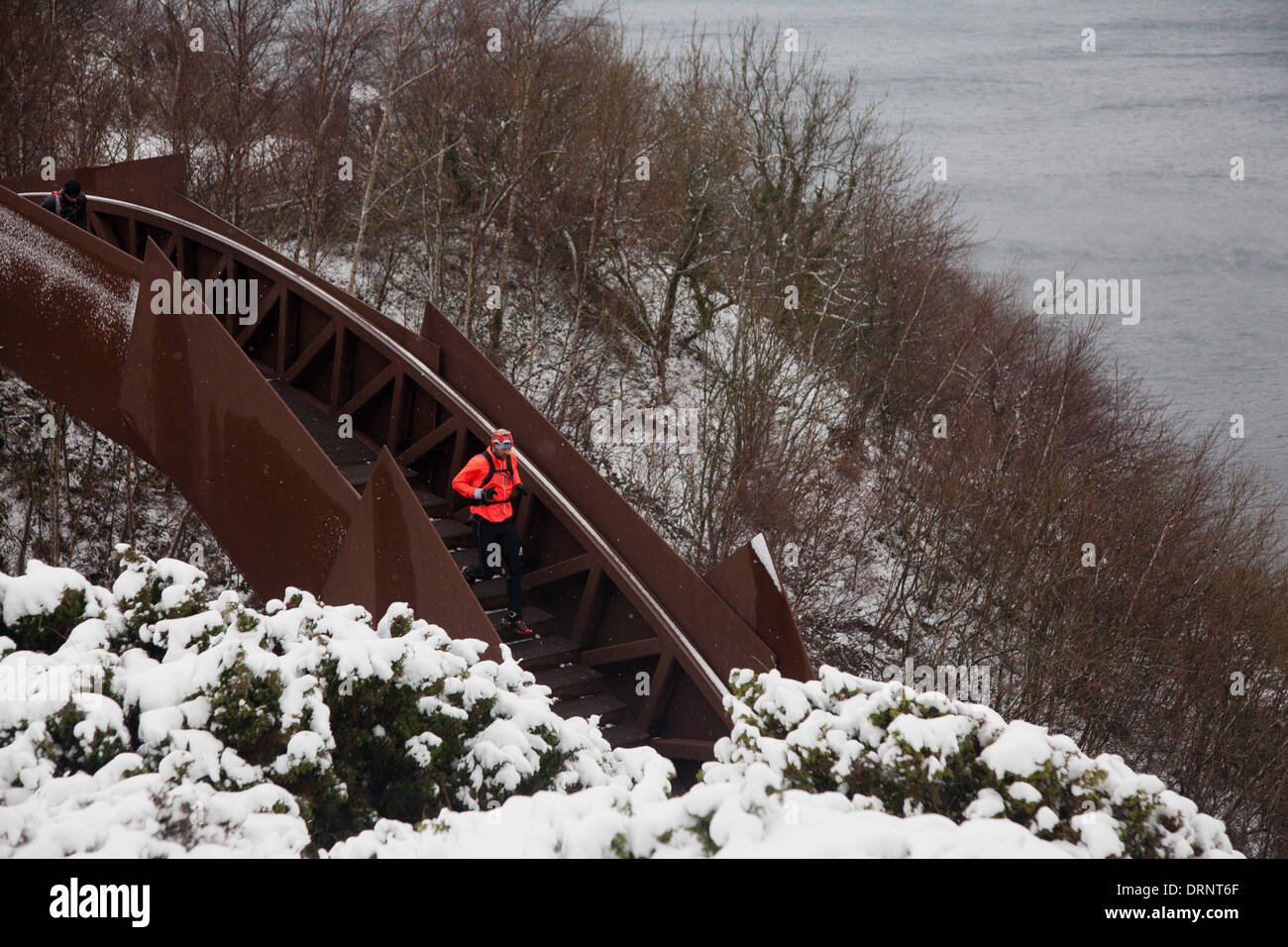 A marathon runner crosses a small metal bridge as part of the trail run ...