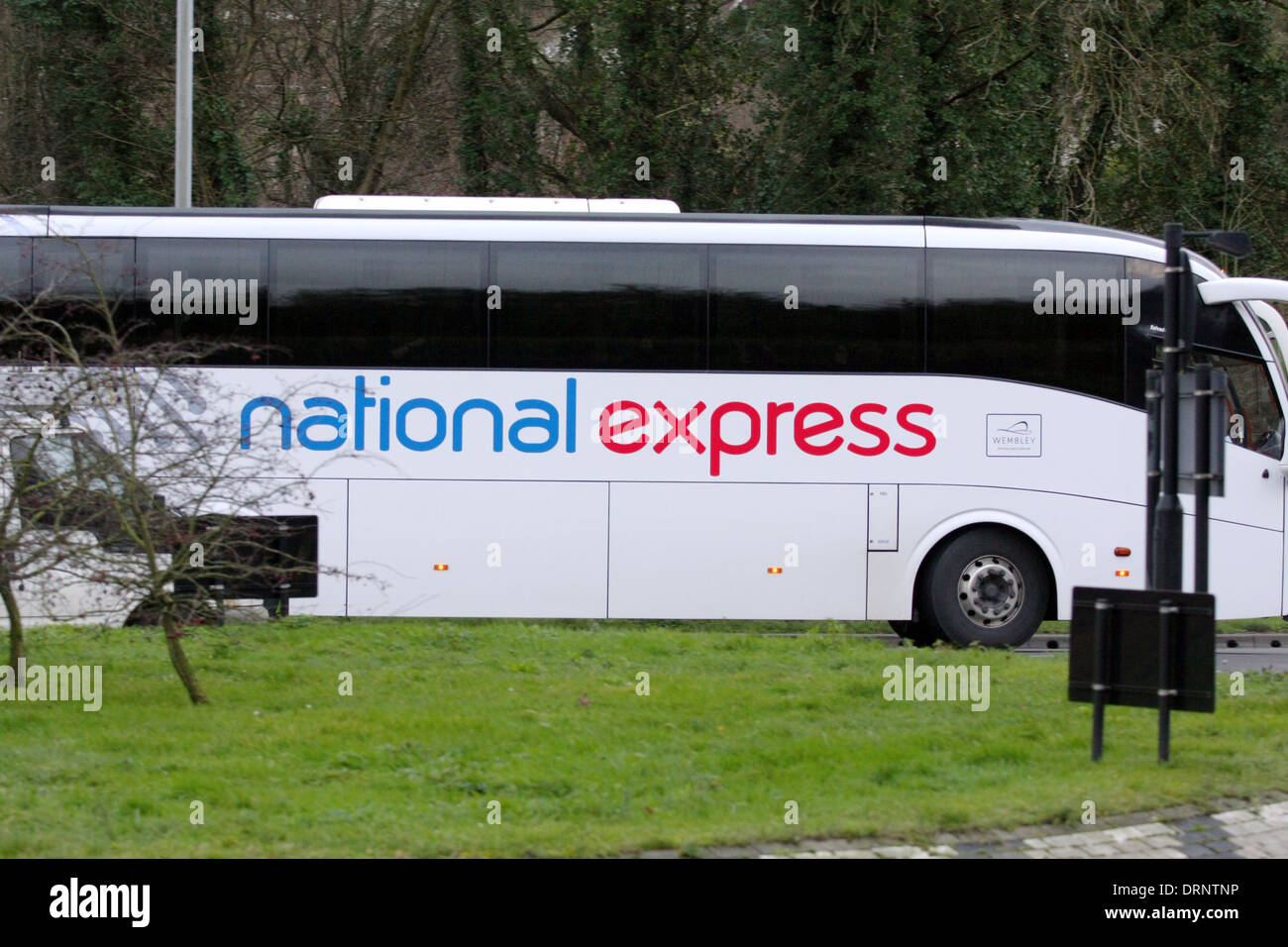 A National Express coach traveling around a roundabout in Coulsdon ...