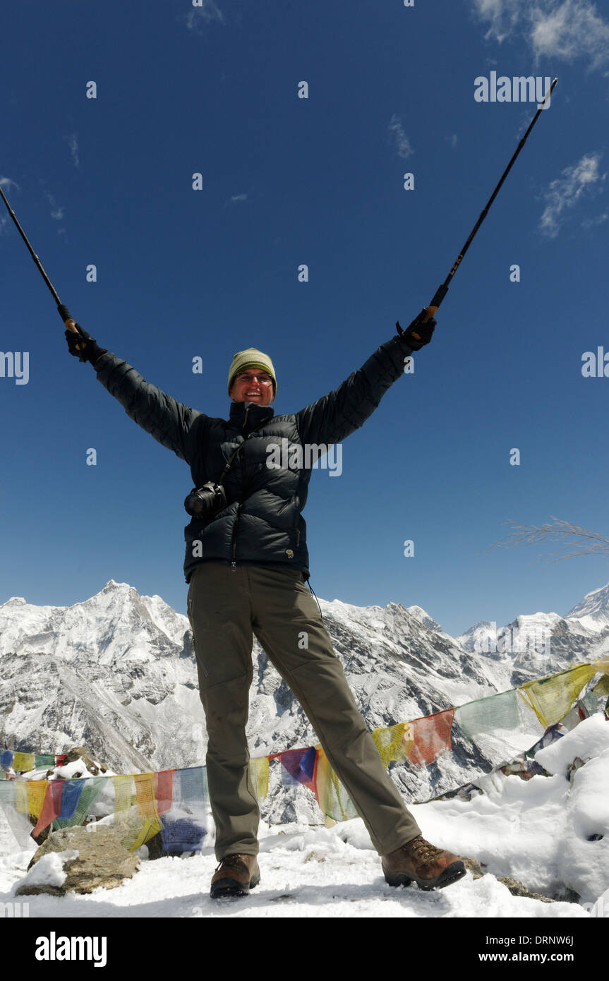 A lady trekker celebrates arriving at the summit of Gokyo Ri, Nepal ...