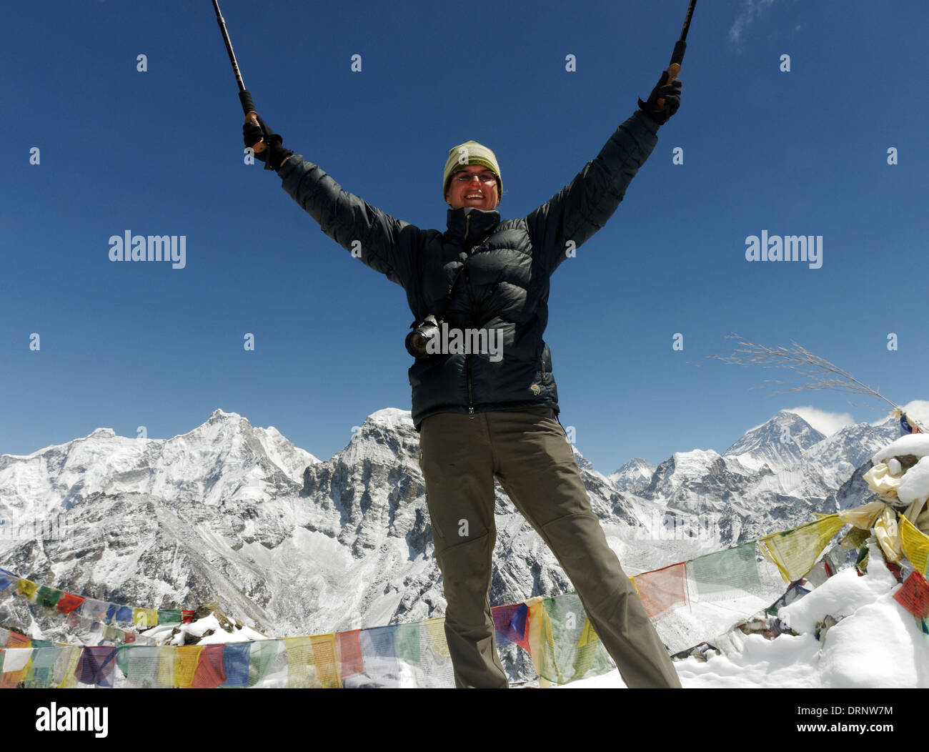 A lady trekker celebrates arriving at the summit of Gokyo Ri, Nepal ...