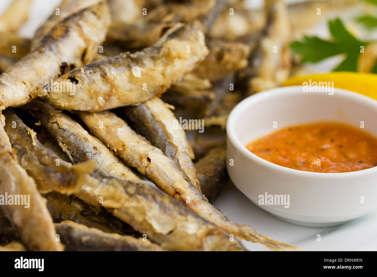 Fried fresh sprat fish with souce. Good seafood Stock Photo - Alamy