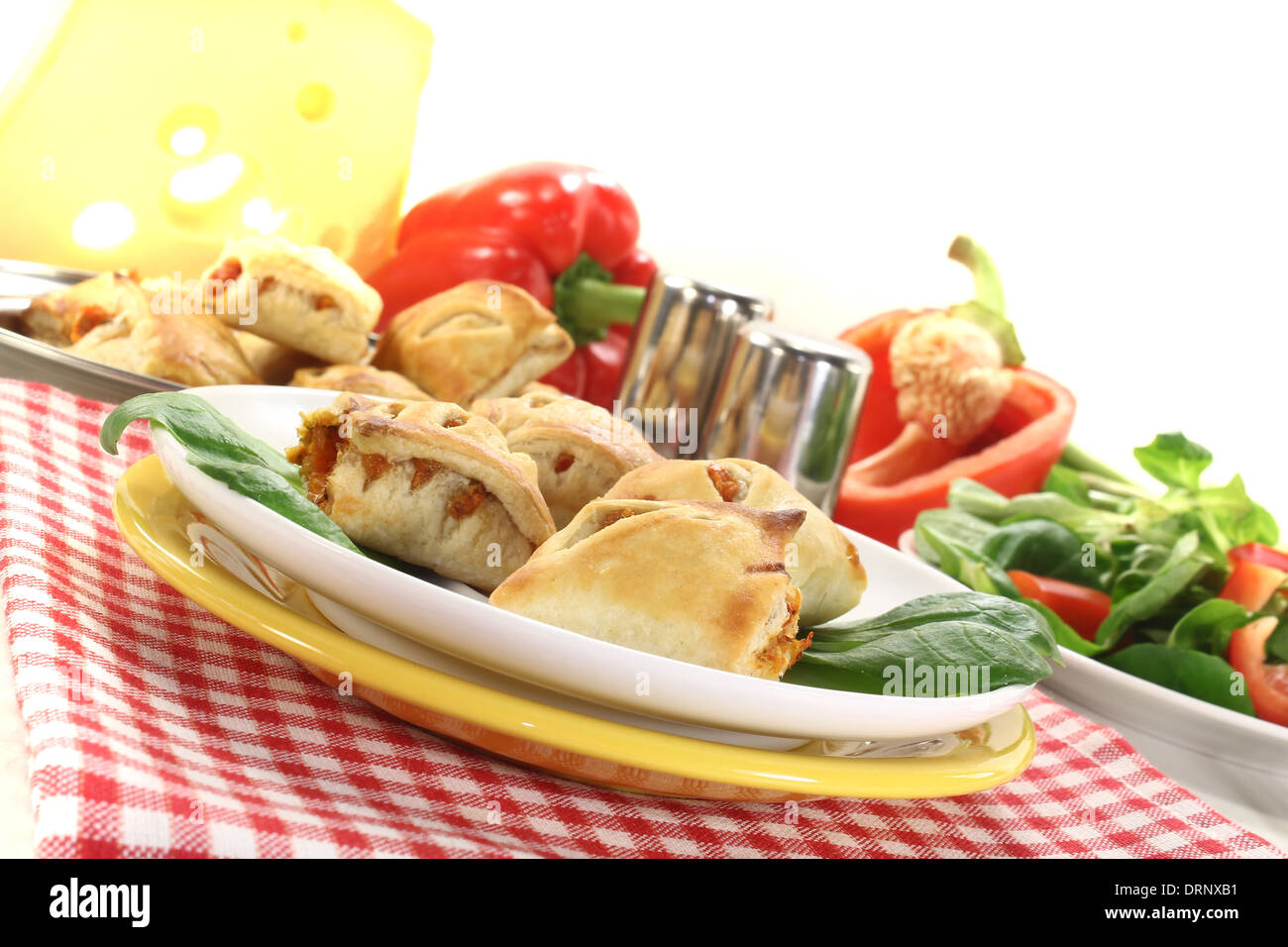 Puff pastry with bell peppers, basil and cheese filling on a light ...