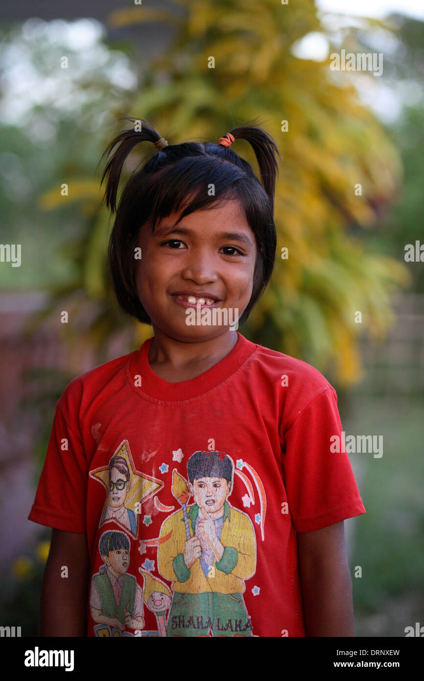 Portrait of smiling Indonesian pretty girl looking at the camera. Sumba ...