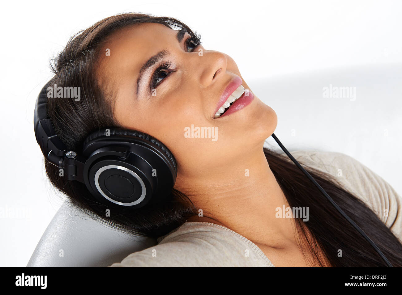 Young beautiful relaxed casual woman listening to music Stock Photo - Alamy