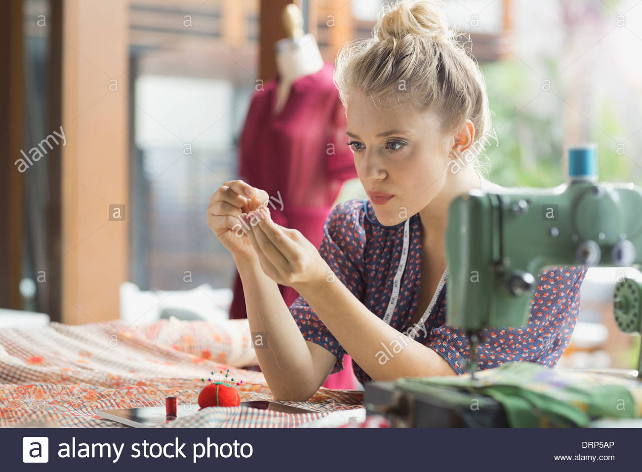 Woman needle threading studio hi-res stock photography and images - Alamy