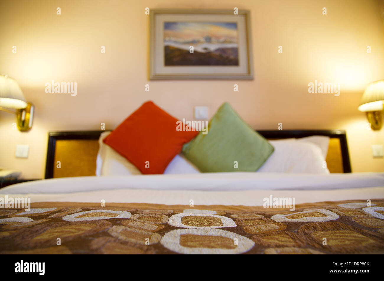 Warmly lit hotel room and bed with shallow depth of field Stock Photo ...