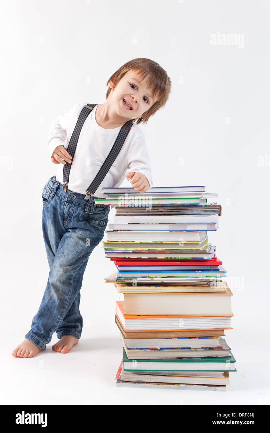 Boy with a pile of books Stock Photo - Alamy