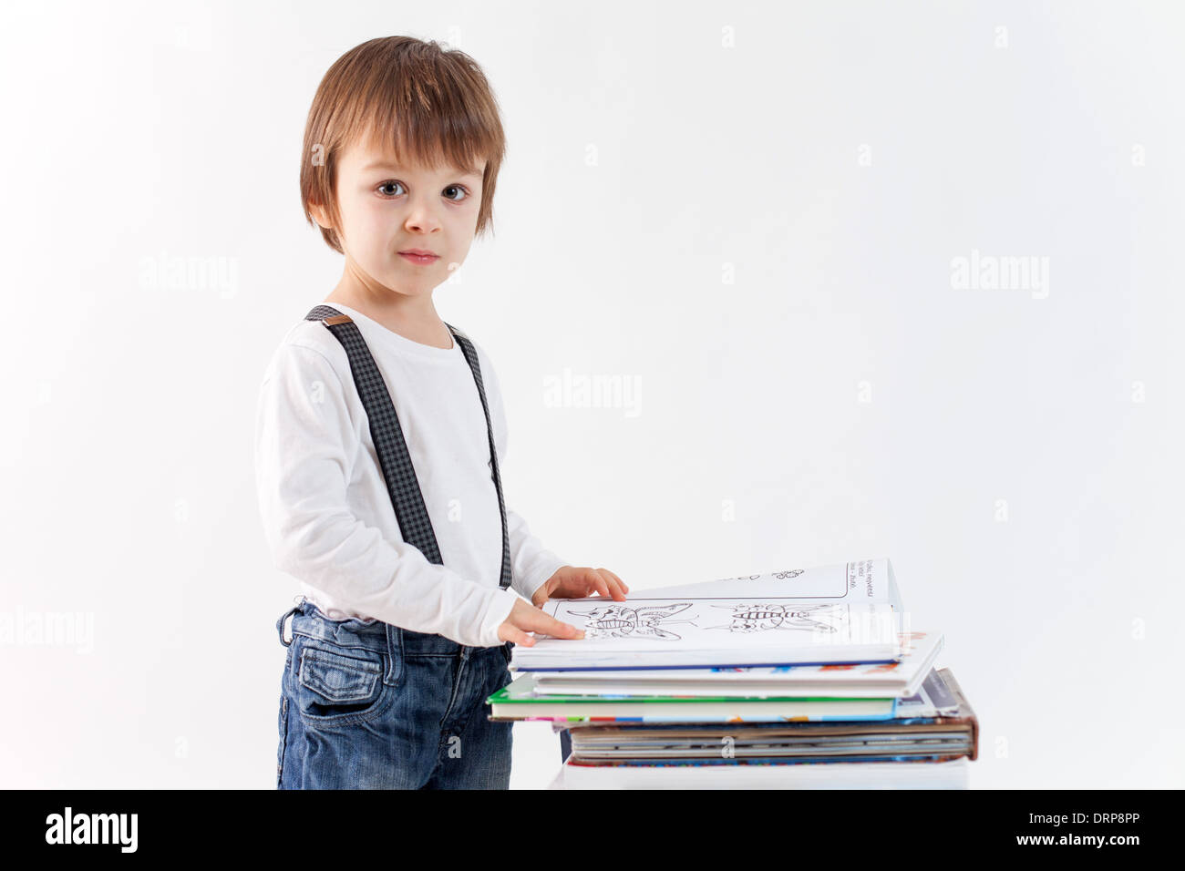 Boy with a pile of books Stock Photo - Alamy